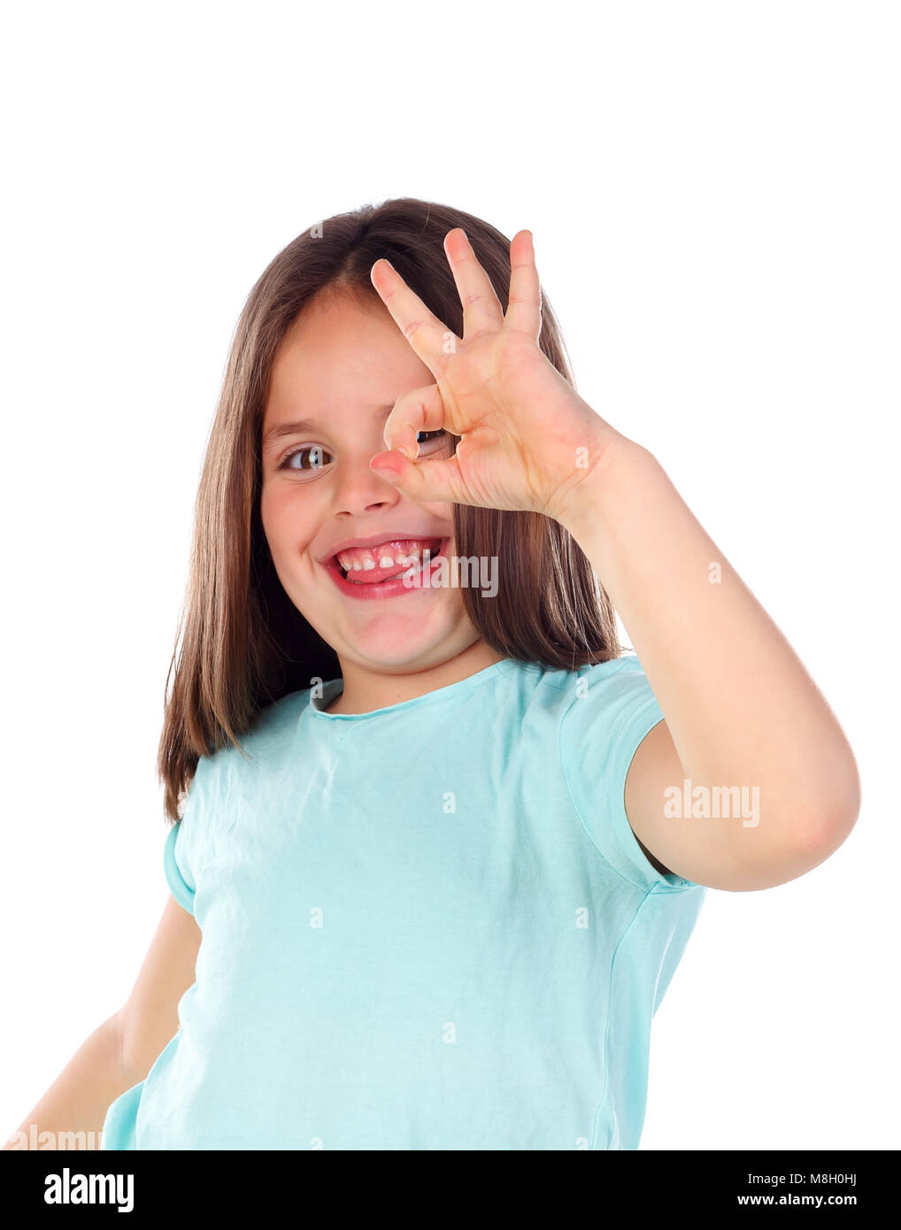 Friendly child saying Ok with her hand isolated on a white background ...
