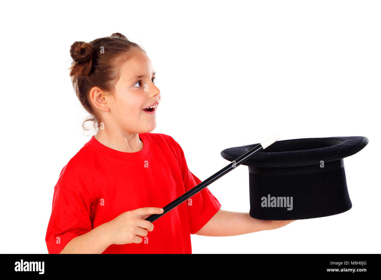Pretty little girl doing magic with a top hat and a magic wand isolated ...