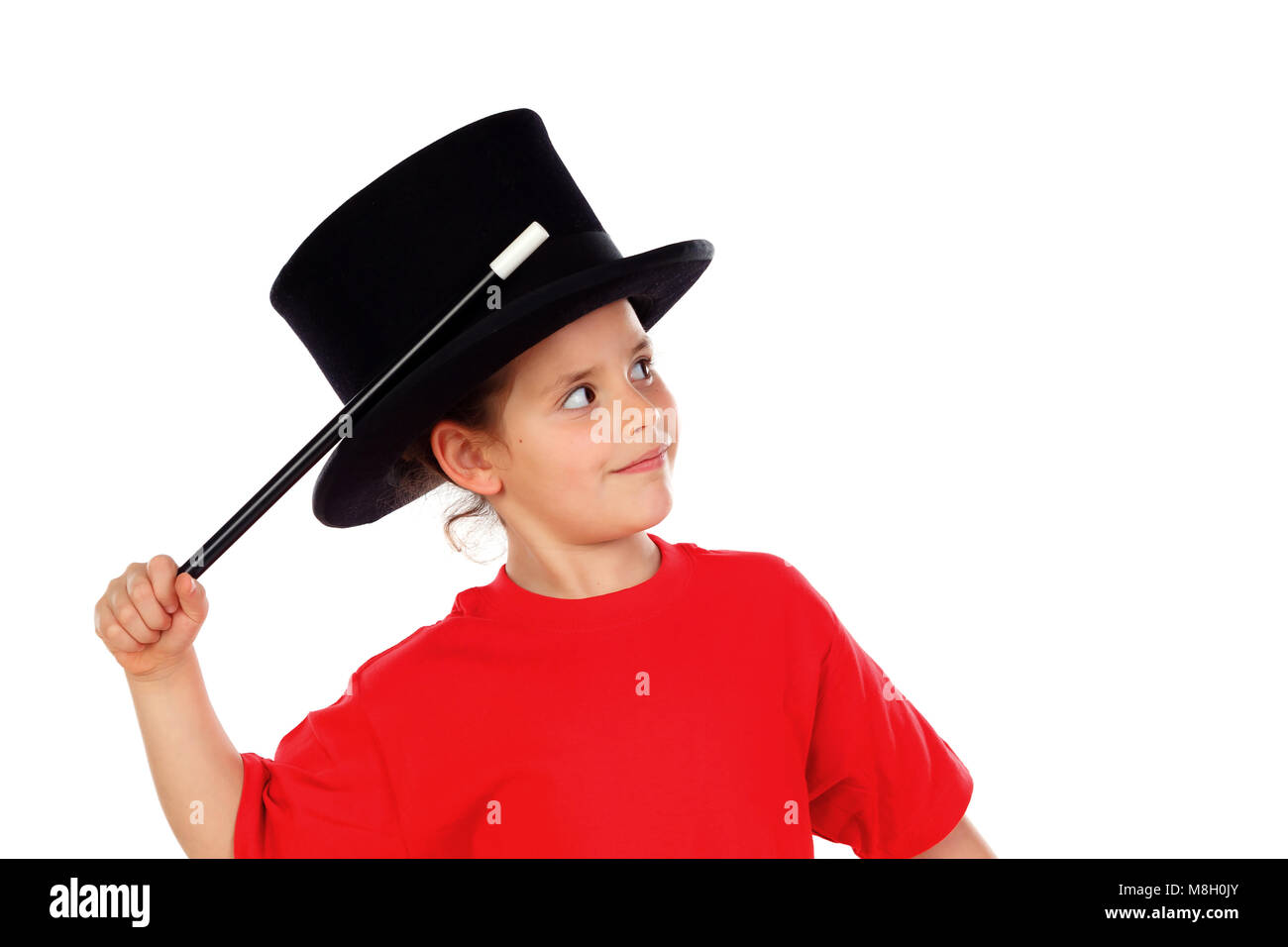 Pretty little girl doing magic with a top hat and a magic wand isolated ...