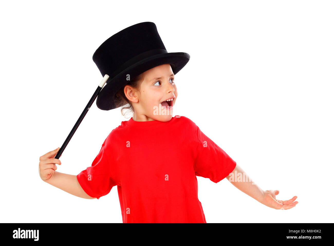 Pretty little girl doing magic with a top hat and a magic wand isolated ...