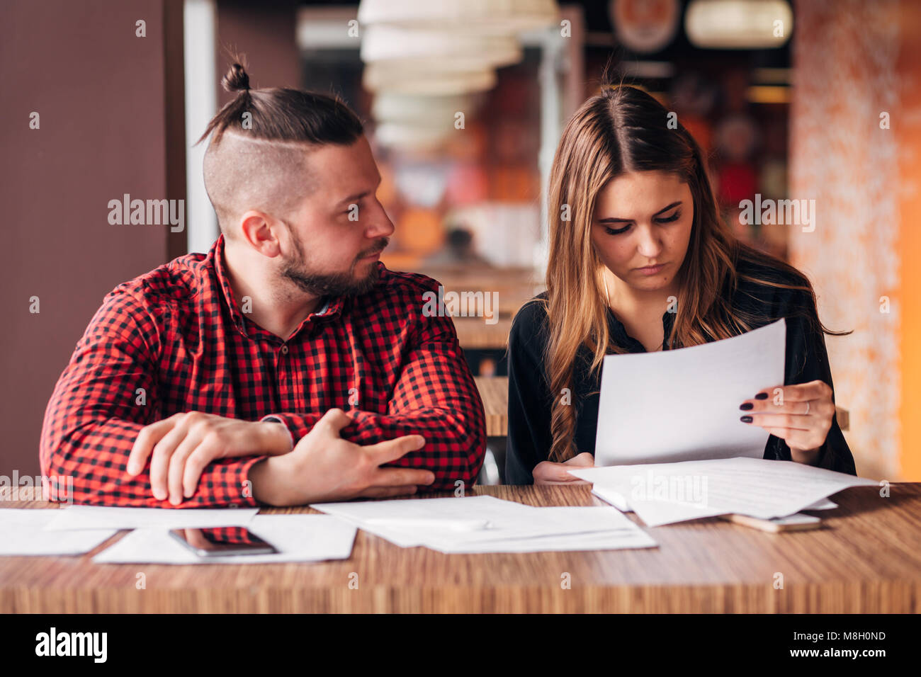 businessman and businesswoman studying documents in a cafe Stock Photo ...