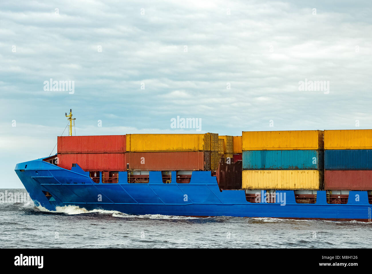 Blue cargo container ship fully loaded underway Stock Photo - Alamy