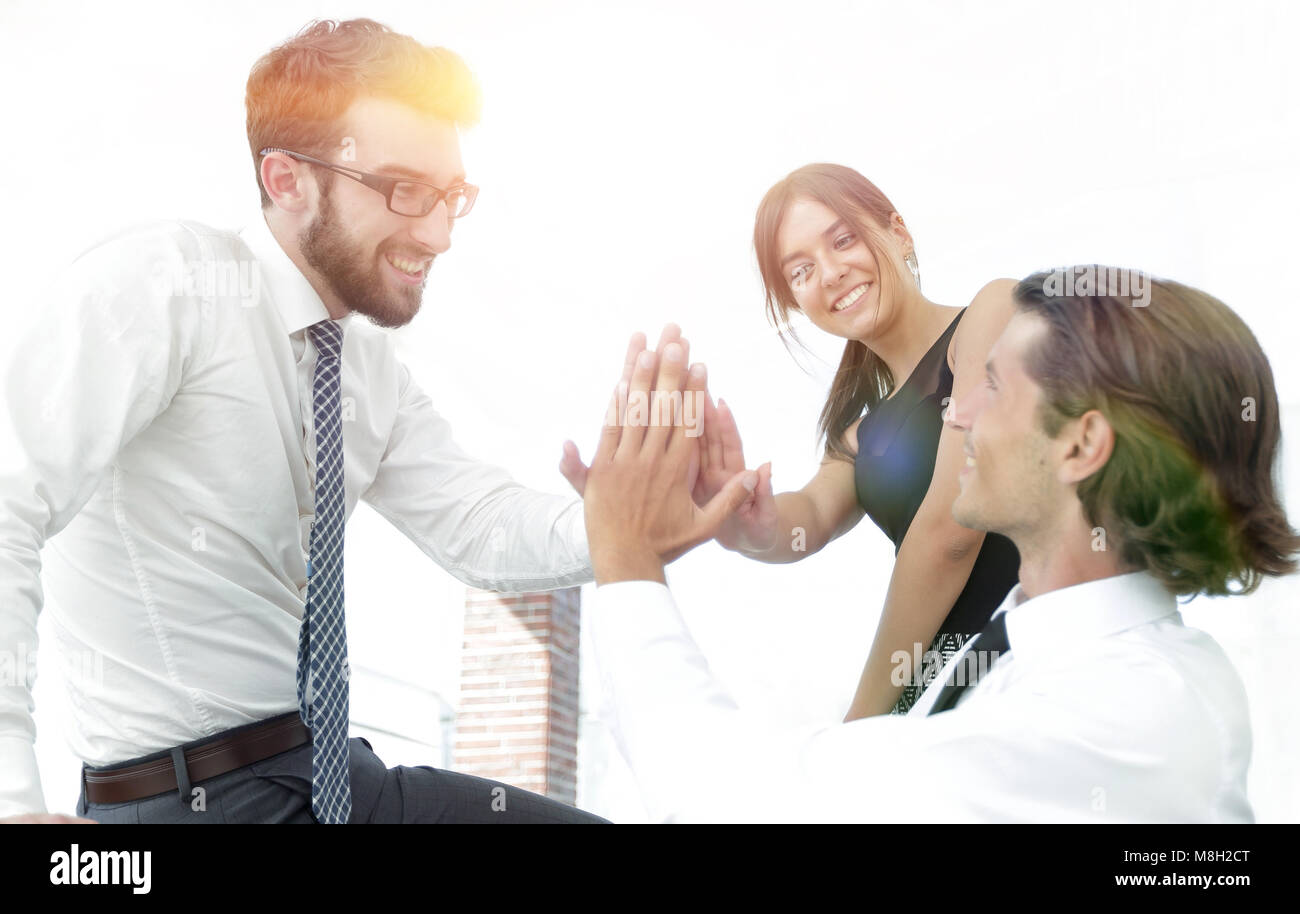 members of the business team give each other high five Stock Photo - Alamy