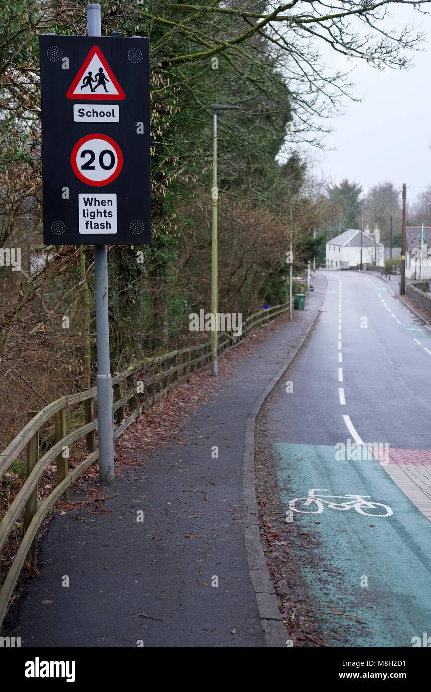 School road sign slow down when lights flash building in background ...