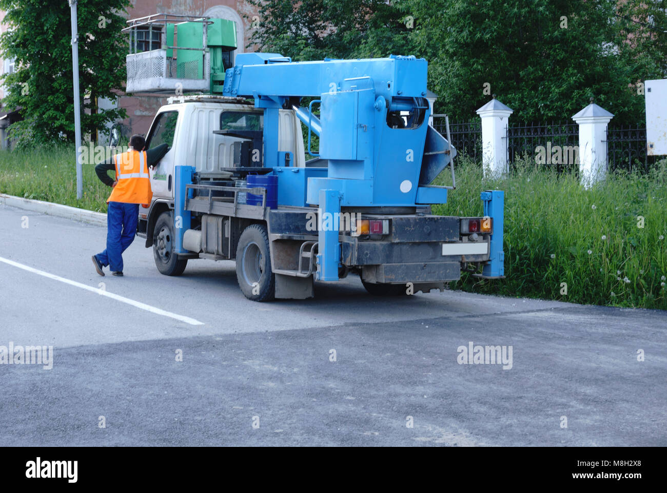 Operator In Safety Helmet and red square shirt controlling Straight ...