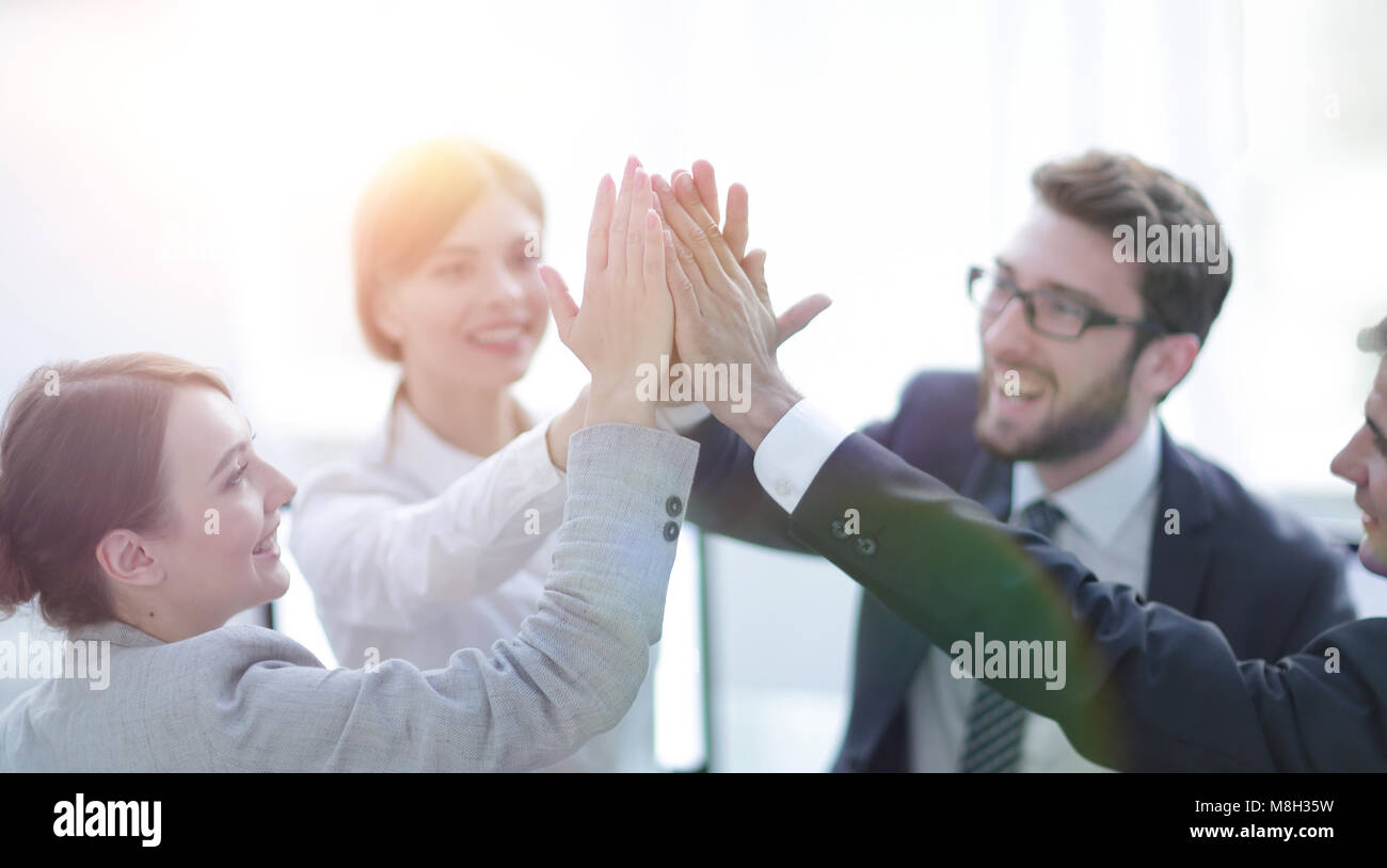 successful business team giving each other a high-five, standing in the ...