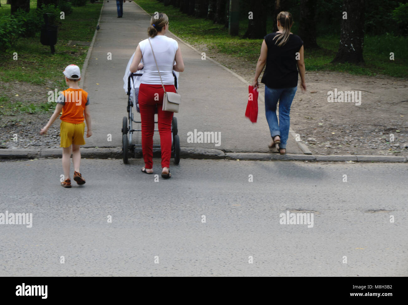 a group of people walking along the path Stock Photo - Alamy