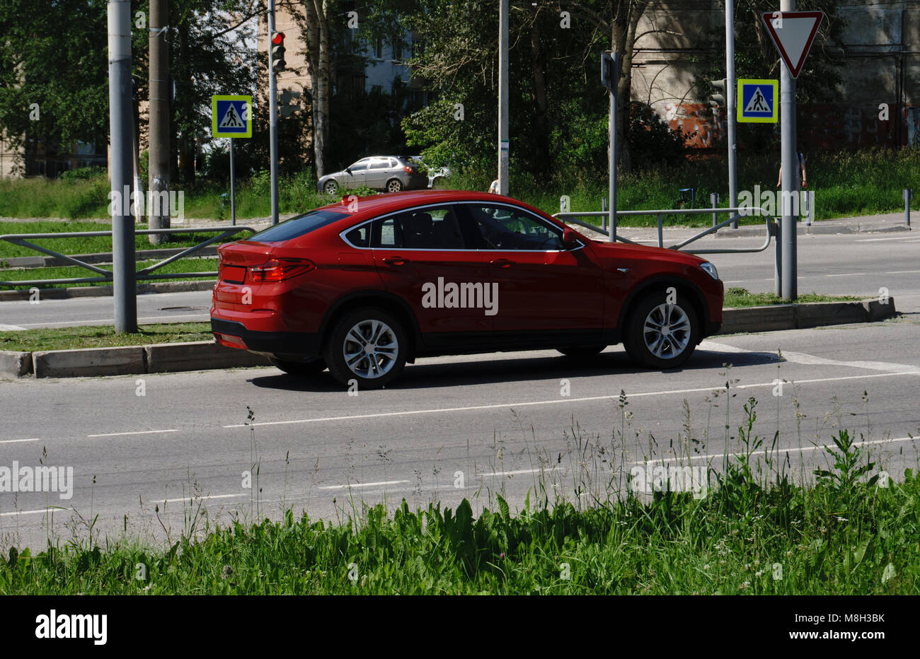 beautiful red car driving on the road Stock Photo - Alamy