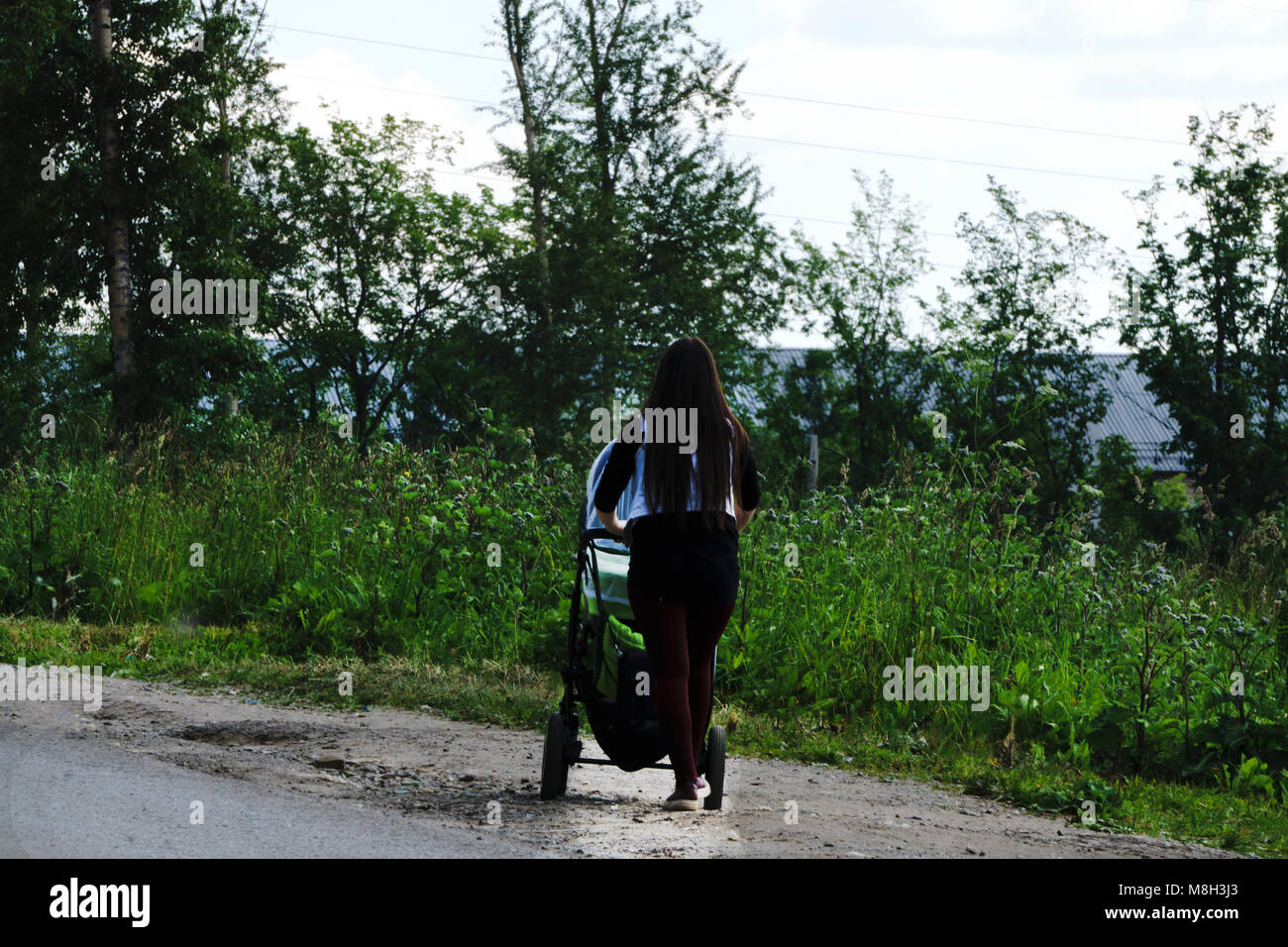 heat and sun outdoors walking girl with pram Stock Photo - Alamy