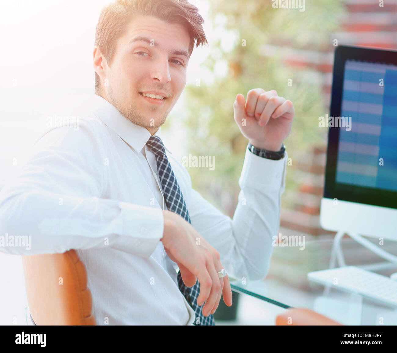 employee sitting in front of a computer screen Stock Photo - Alamy