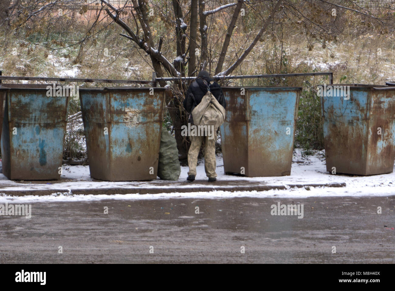 The lame homeless vagrants near the garbage cans looking for empty ...