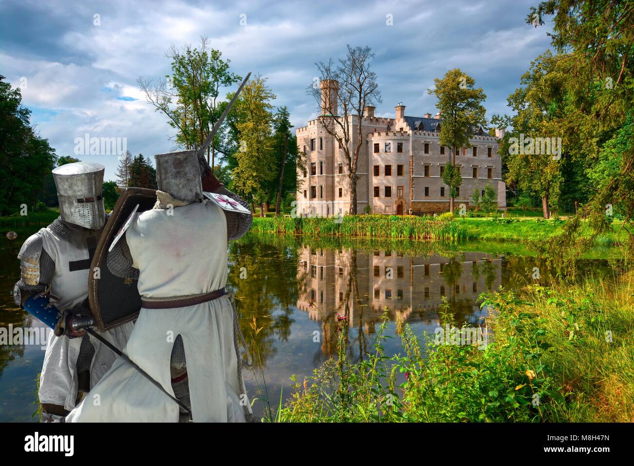 Medieval fighting knights in front of neo-Gothic style castle ...