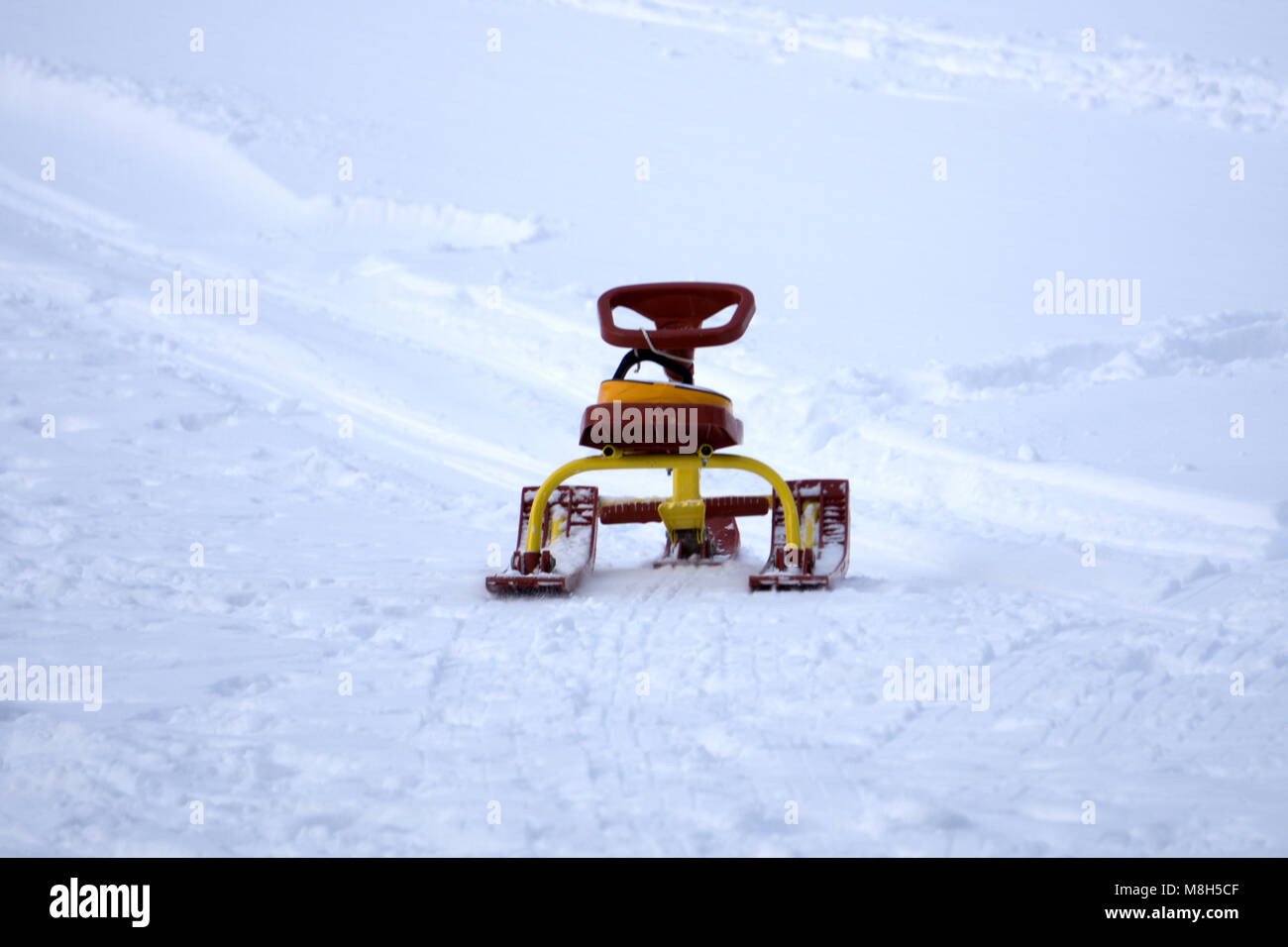 snow sled steering wheel and snowmobile Stock Photo - Alamy