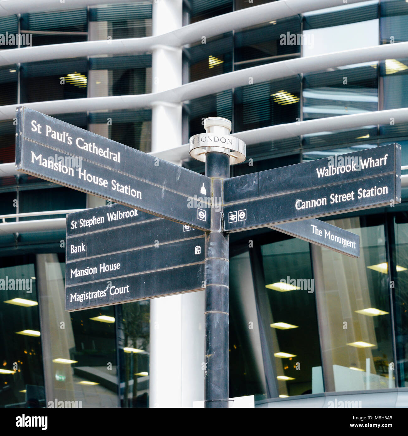 Signpost in the City of London, England, UK pointing to various ...