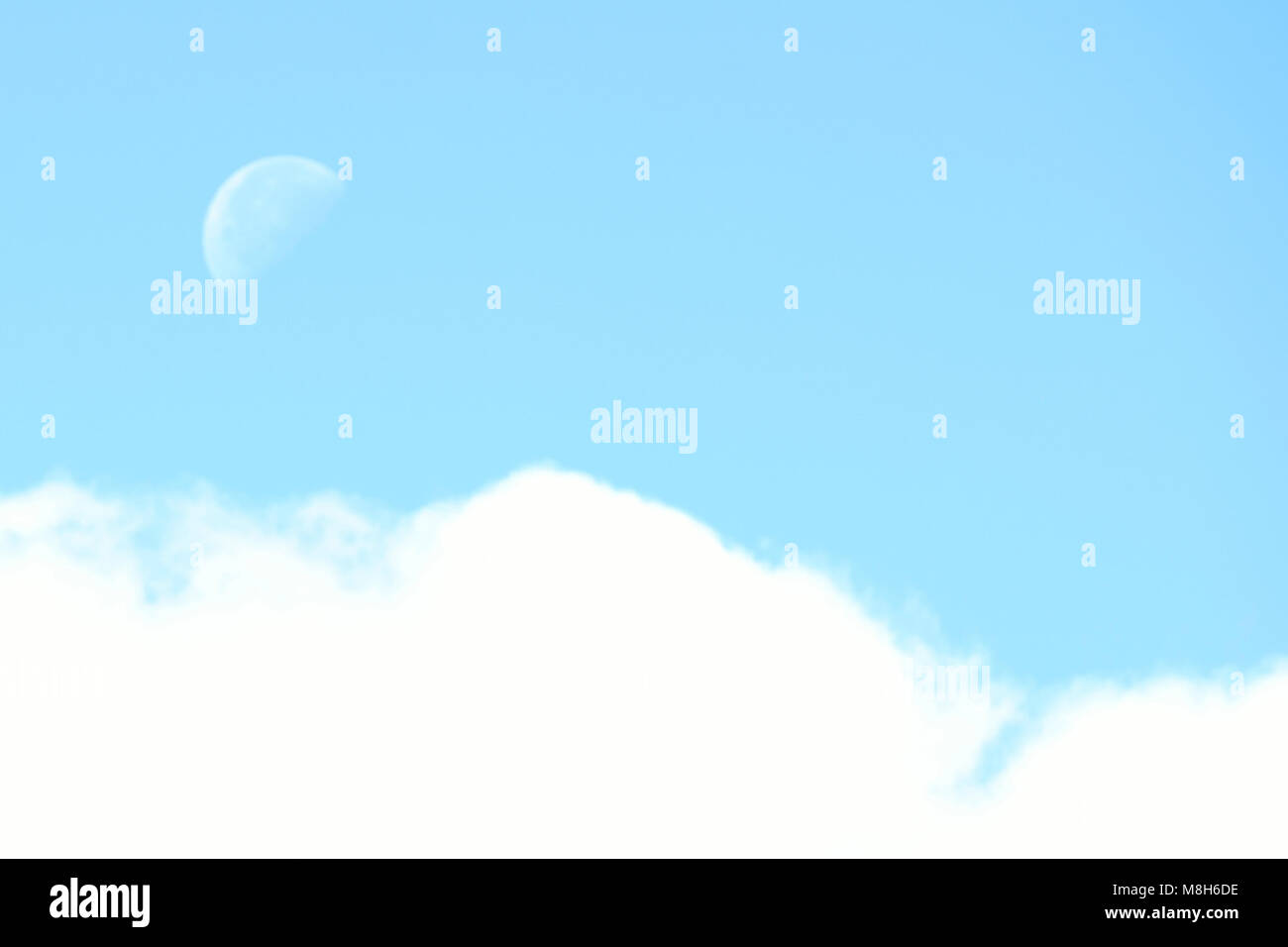 Cloudy blue sky with rising moon Stock Photo - Alamy