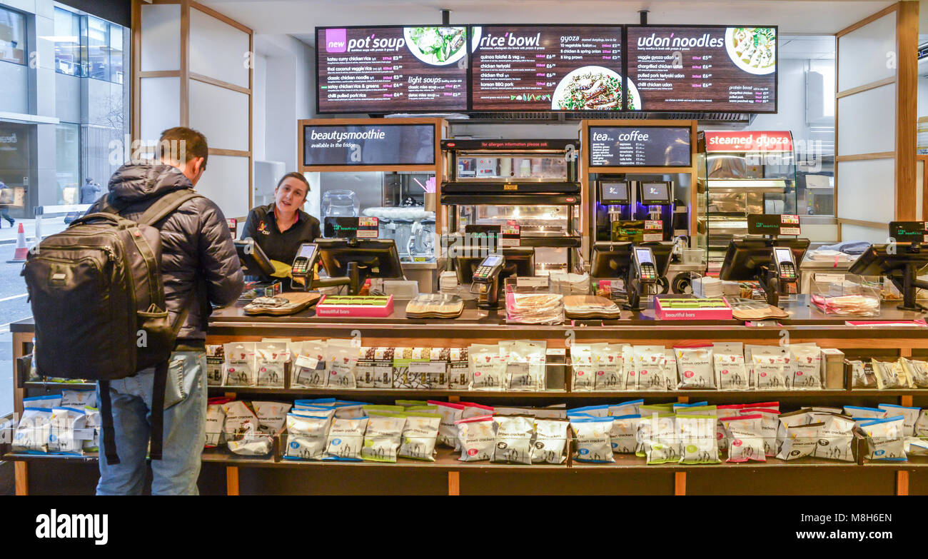 Customer at counter paying for food at Itsu Health and Happiness ...