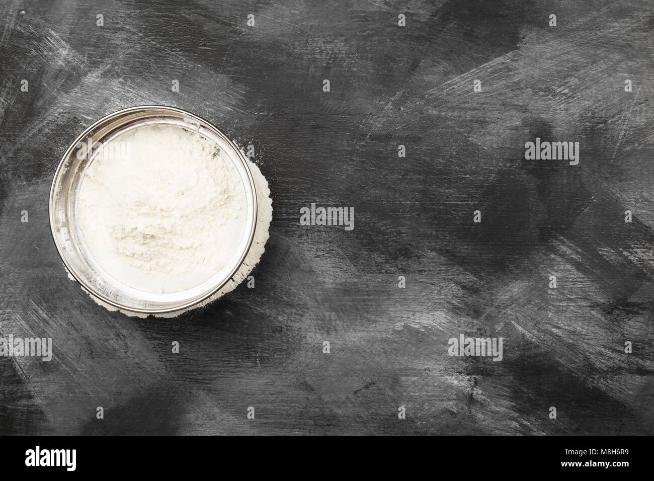 Sieve with flour on dark background. Top view, copy space. Food ...