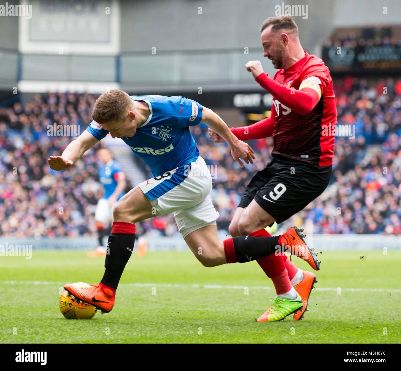 Rangers' Greg Docherty (left) is tripped by Kilmarnock's Kris Boyd ...