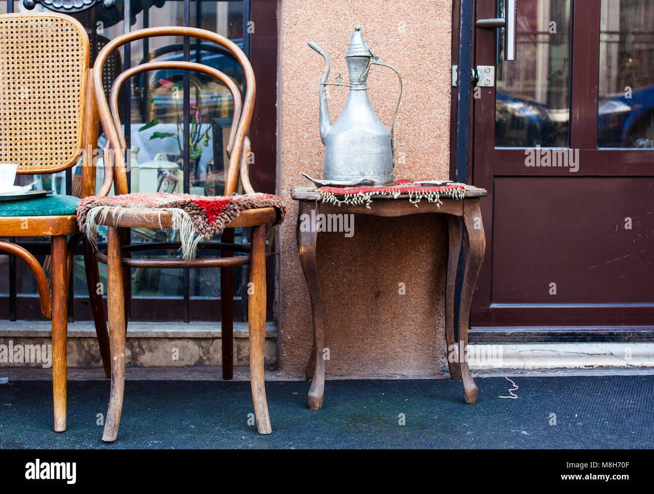 View of ancient aluminium teapot on chair in Sarajevo Stock Photo - Alamy