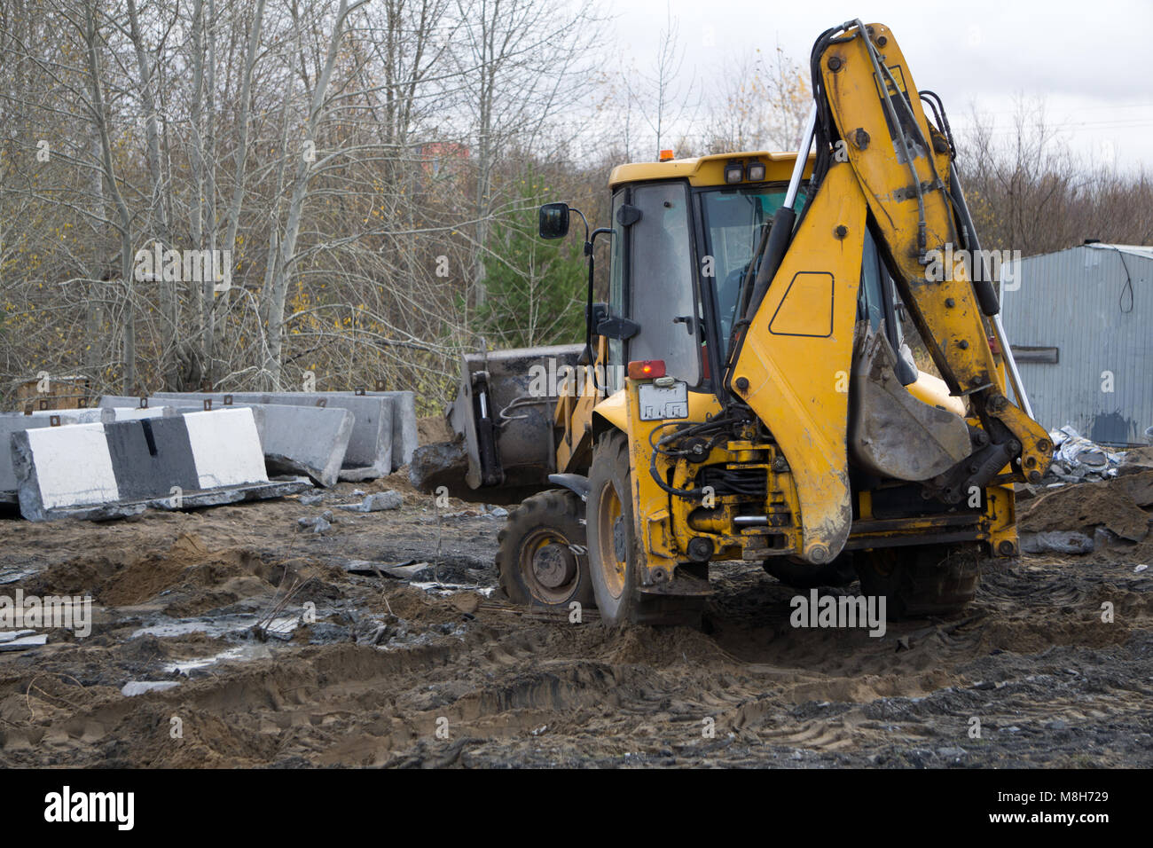 Grader clearing and leveling construction site surface. Grader ...
