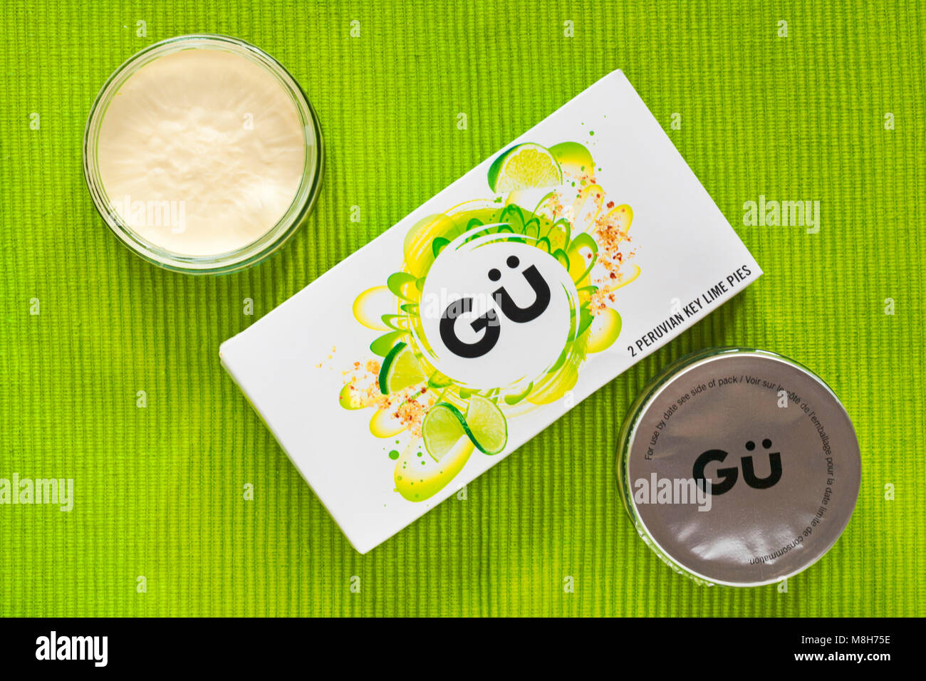 Gü box of Gu 2 Peruvian key lime pies set on lime green textured ...