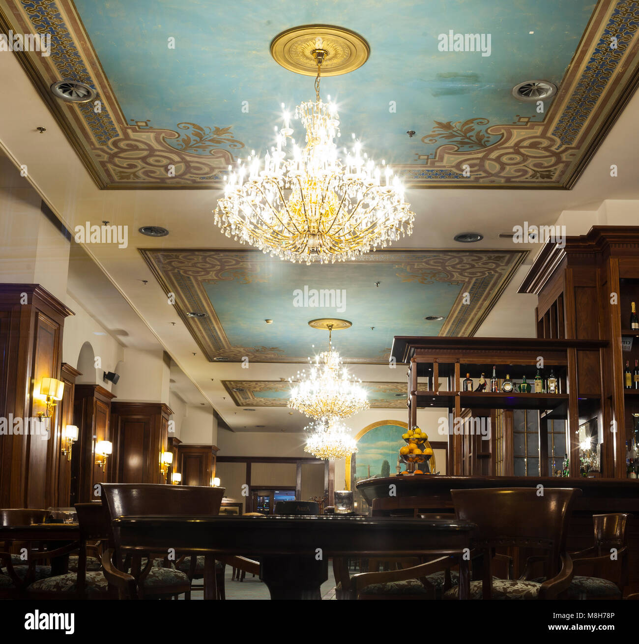 Interior of restaurant illuminated by ancient chandelier Stock Photo ...