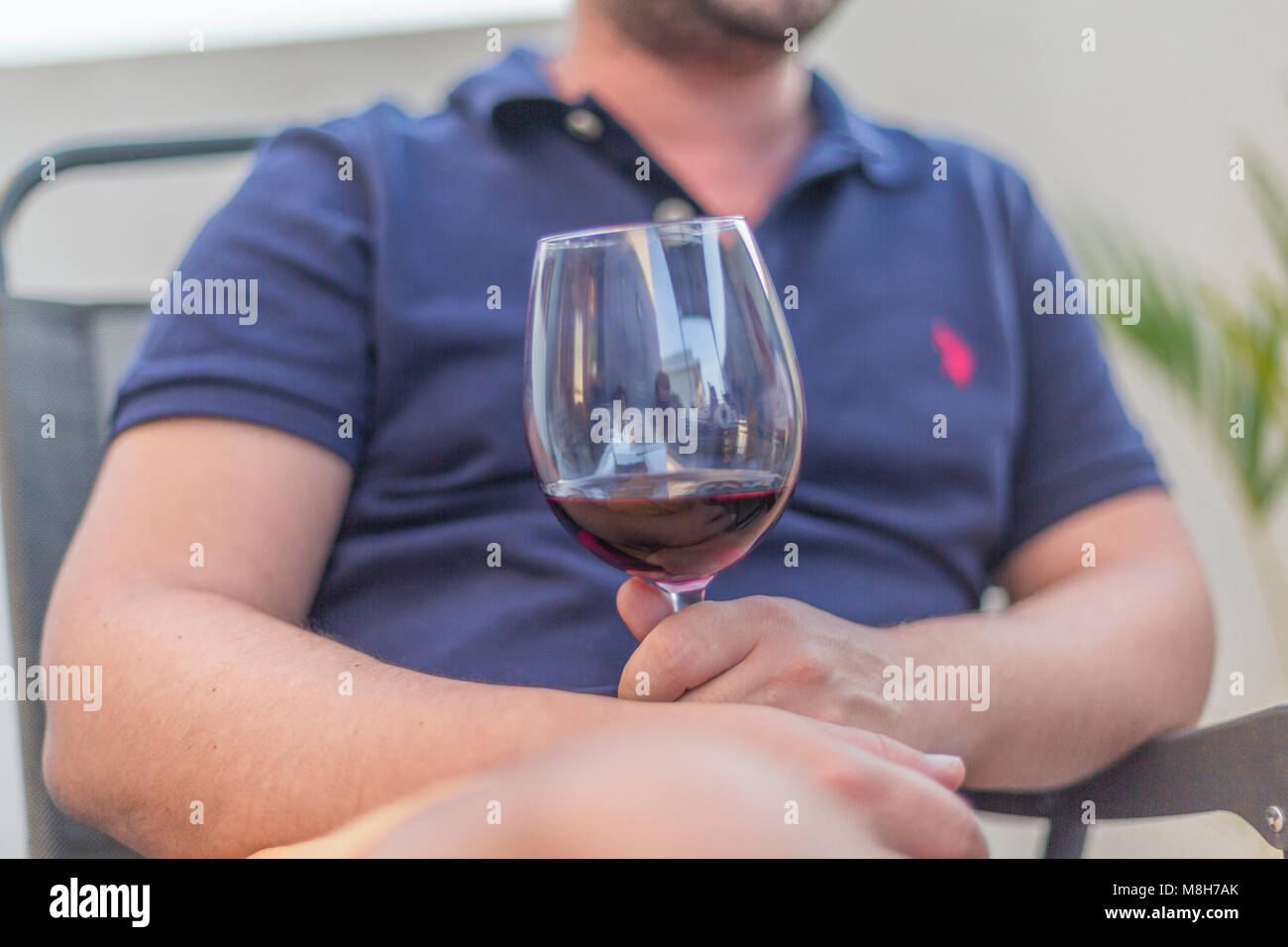 Man hand picks up wine glass Stock Photo - Alamy