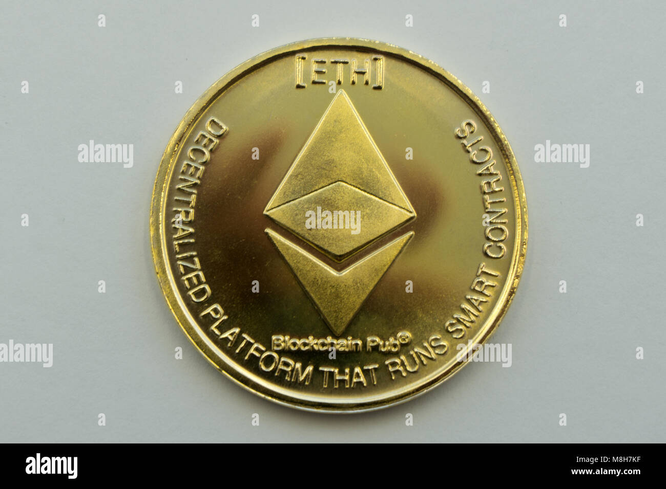 Stack of ether coins or ethereum on gold background to illustrate ...