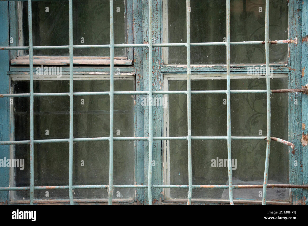 A gloomy window with a lattice in a concrete wall Stock Photo - Alamy