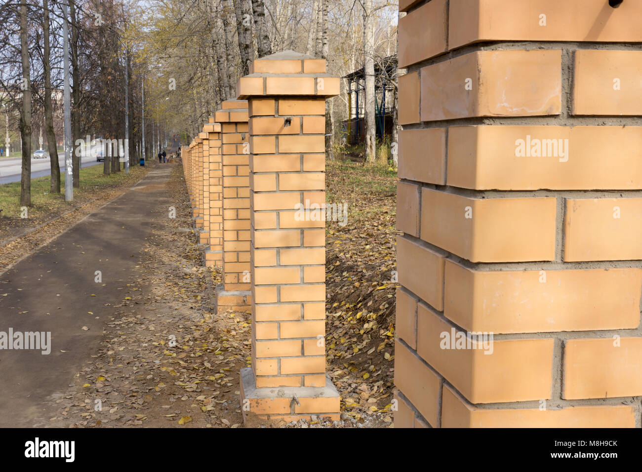Red brick fence on sunset structure surface Stock Photo - Alamy
