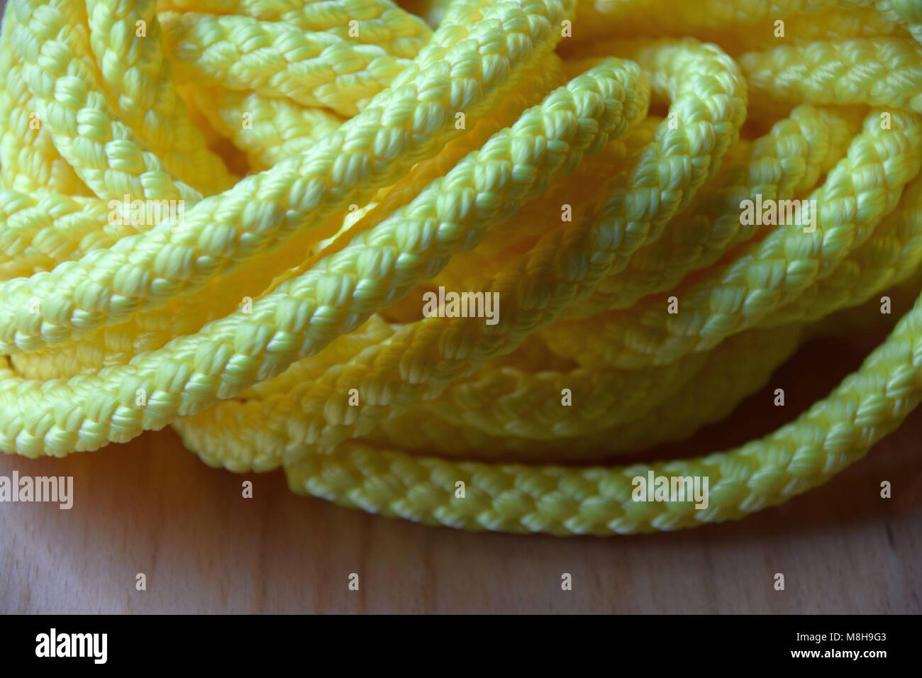 yellow industrial ropes on wooden background Stock Photo - Alamy