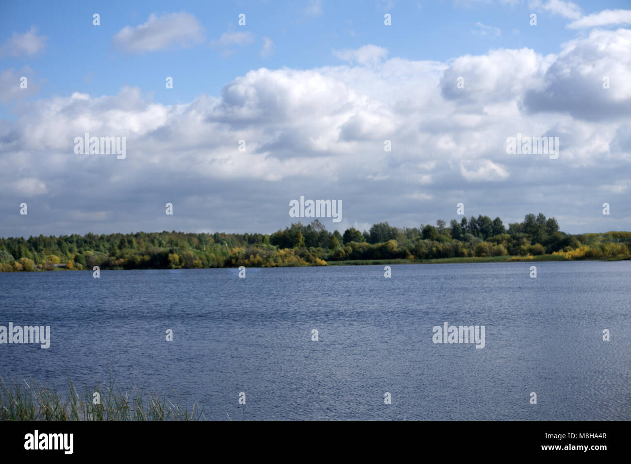 blue sky white clouds green mountain inverted reflection in water Stock ...