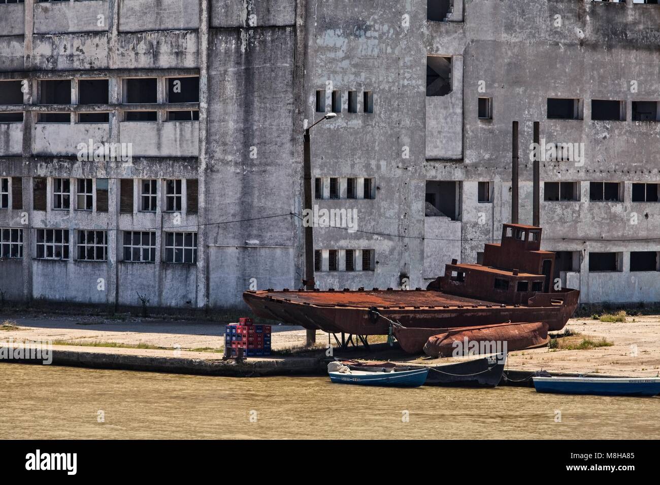 RUSTING SHIPS ONSHORE ABOVE THE DANUBE IN FRONT OF EMPTY AND ABANDONED ...