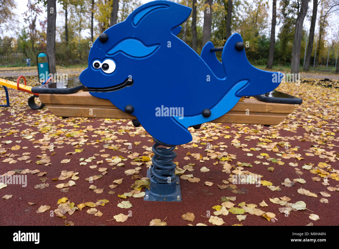 Spring teeter at a playground in a park in summer time Stock Photo - Alamy