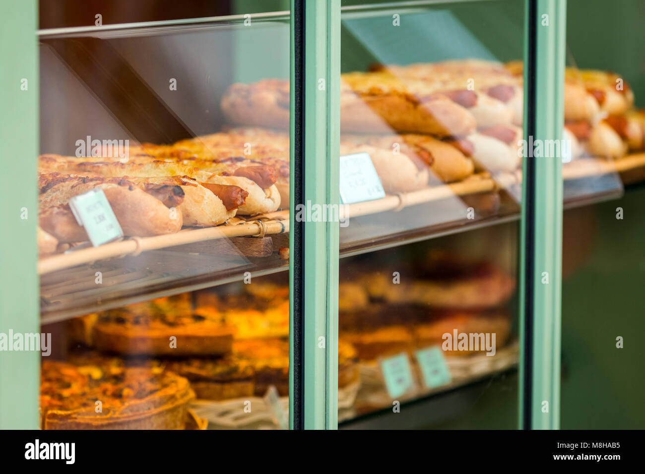 Shiny glass shop windows with hot dogs and snack food for sale Stock ...