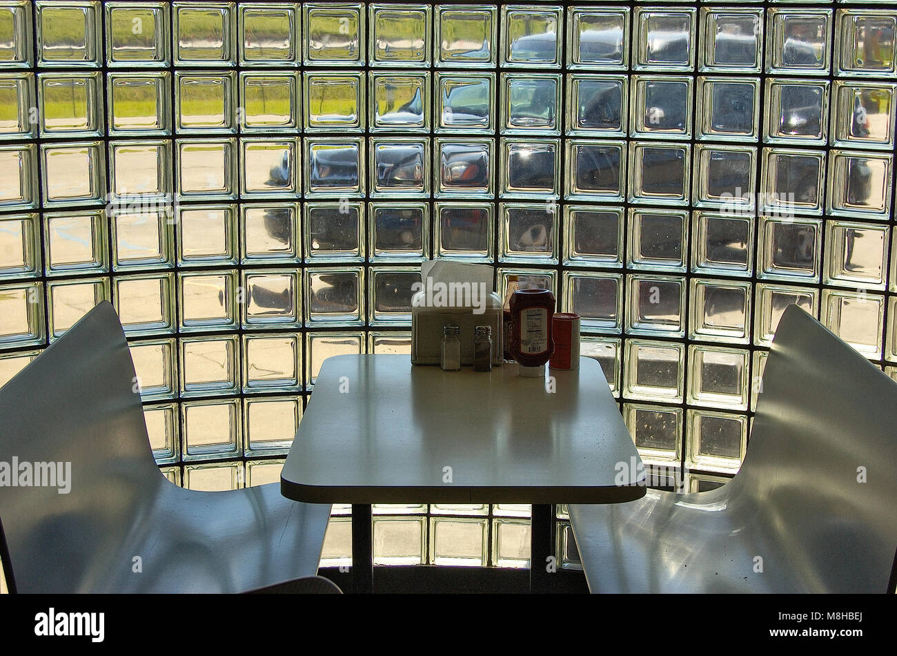 A booth in a cafe or restaurant with glass brick wall Stock Photo - Alamy