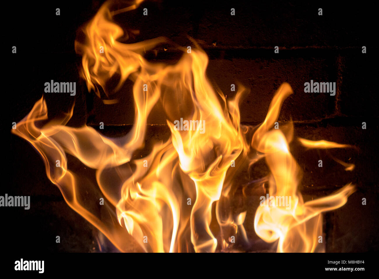 red yellow fire in the fireplace close-up. flames. Fire background ...