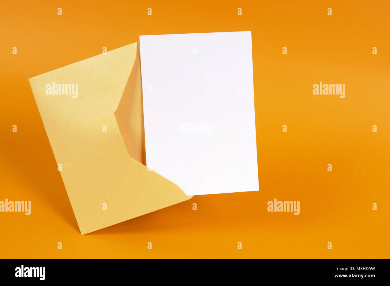 Metallic gold envelope with blank message card letter or invitation ...