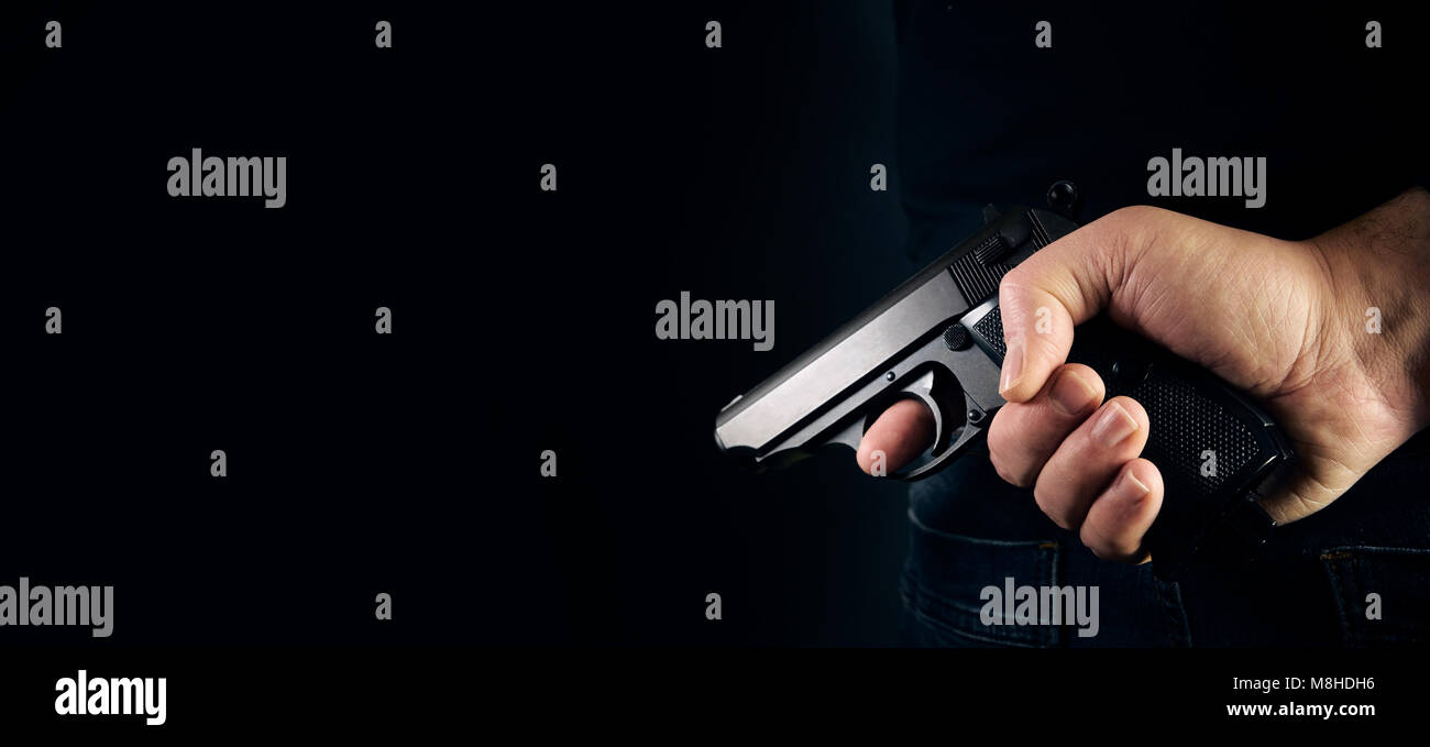Hand shooting gun on black background killer concept Stock Photo - Alamy