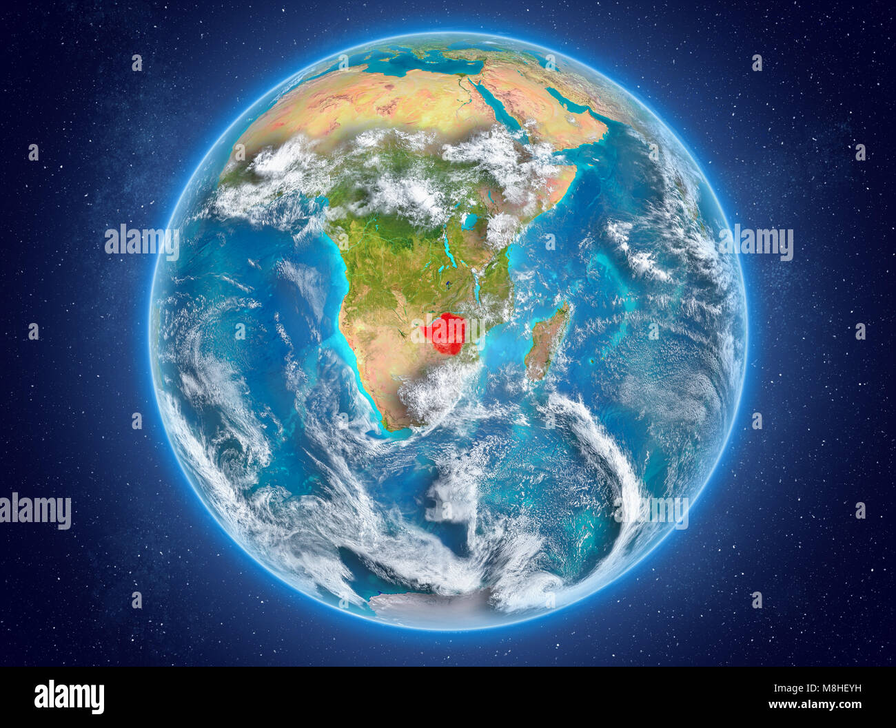 Zimbabwe in red on model of planet Earth with clouds and atmosphere in space. 3D illustration ...