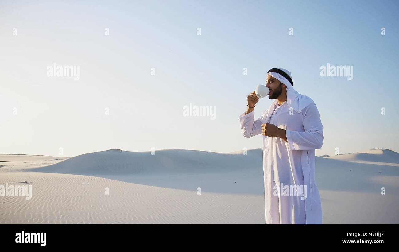 Good morning for male sheikh in middle of huge desert over cup o Stock ...