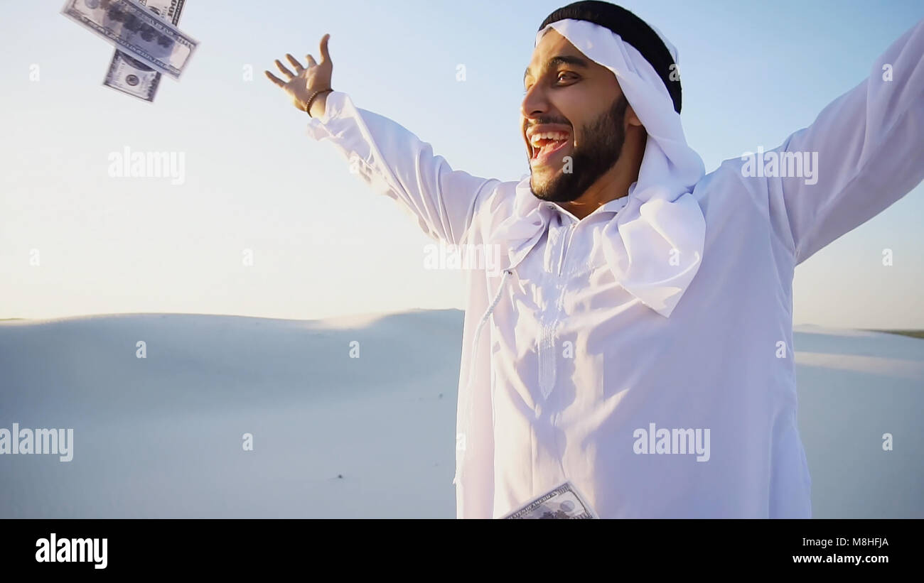 Successful Arab sheikh considers banknotes and happy, standing i Stock ...