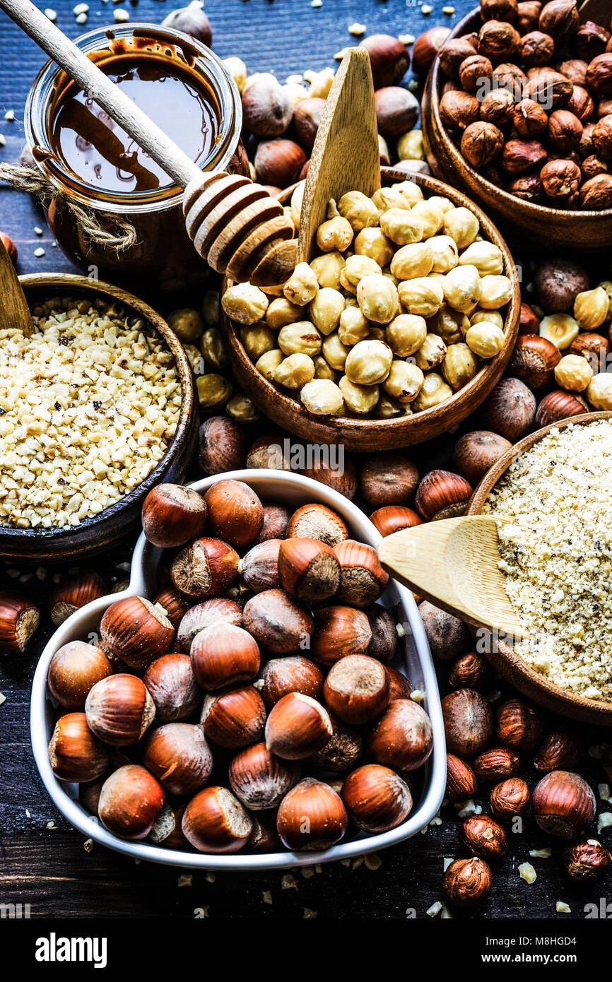 Different types of hazelnuts on dark wooden background with copyspace ...