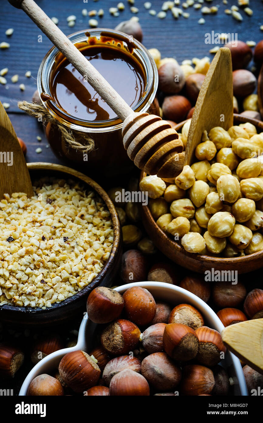 Different types of hazelnuts on dark wooden background with copyspace ...