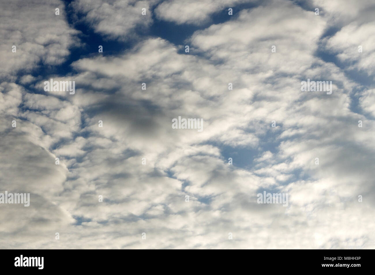 Beautiful sun rays from behind clouds on blue sky Stock Photo - Alamy