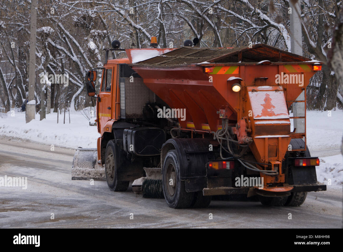 To snowblower clears the road and sand Stock Photo - Alamy