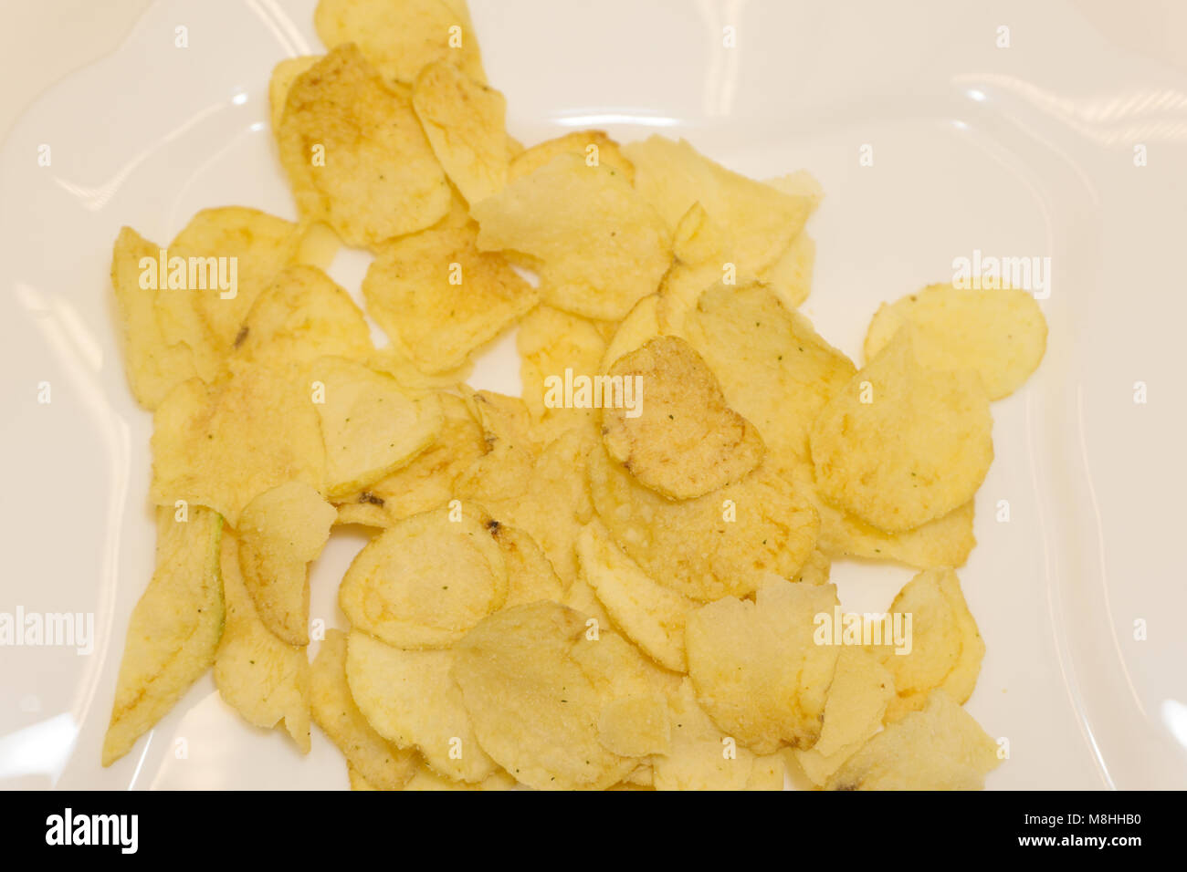 Chips in a plate isolated on white background Stock Photo - Alamy
