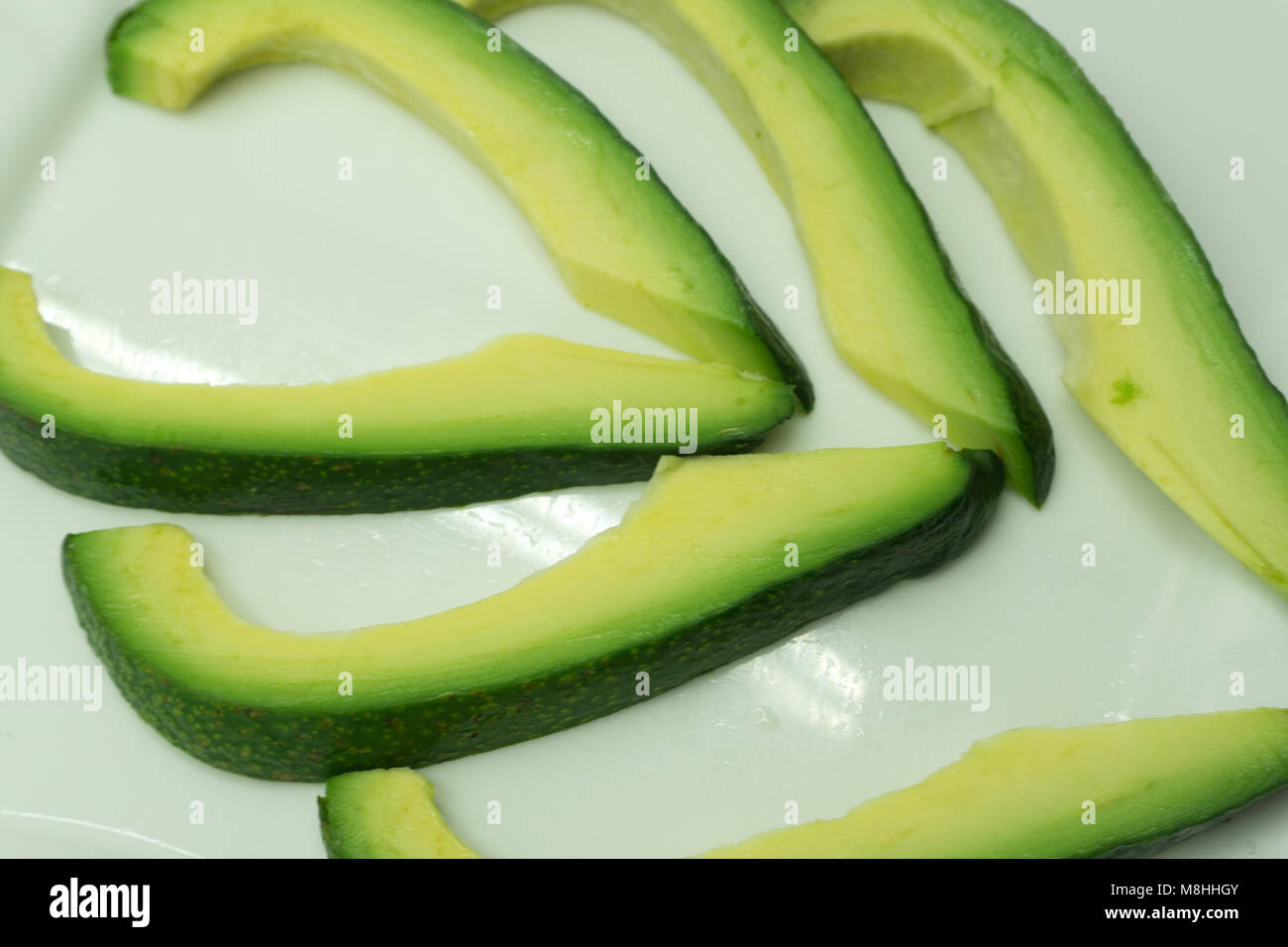 Pieces of avocado isolated on white Stock Photo - Alamy