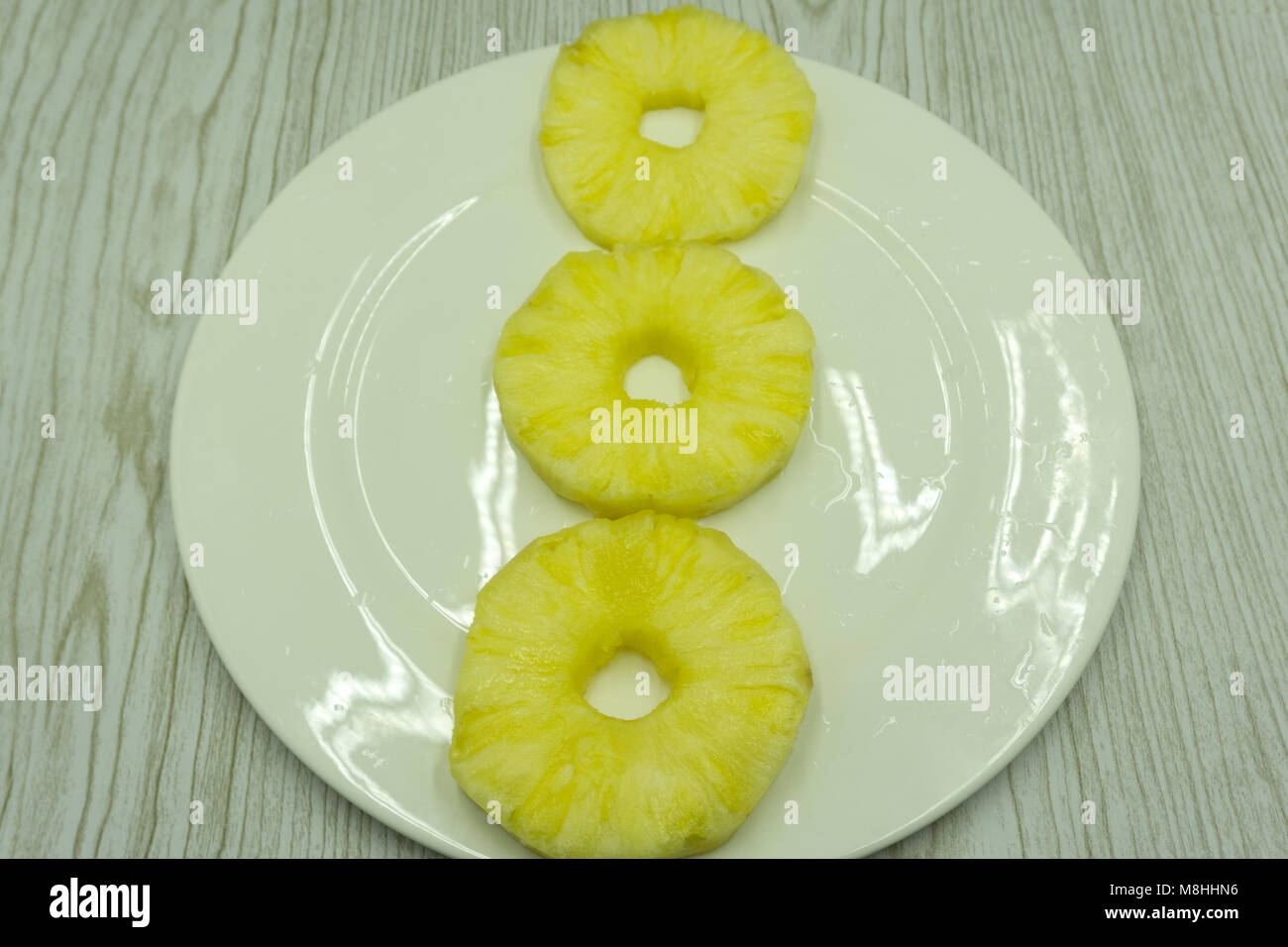 Wheel dessert pineapple with cream isolated on white Stock Photo - Alamy