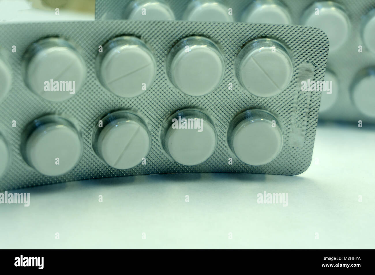 Tablets in blisters on a white background Stock Photo - Alamy